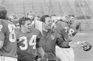 Coach Alex Agase celebrating with star running back Mike Adamle #34